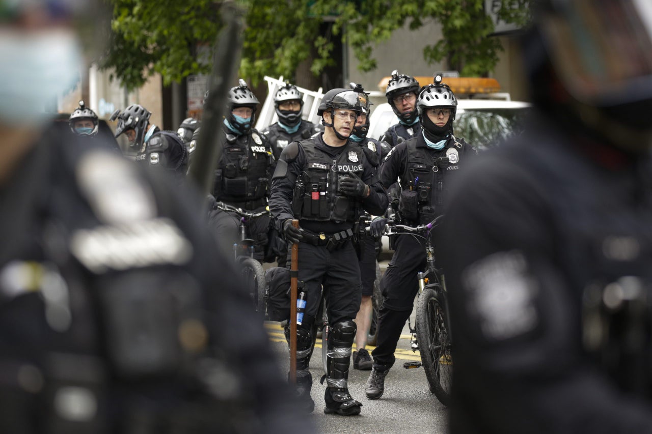 Seattle Police Officer On Leave After Rolling Bike Over Protester's ...